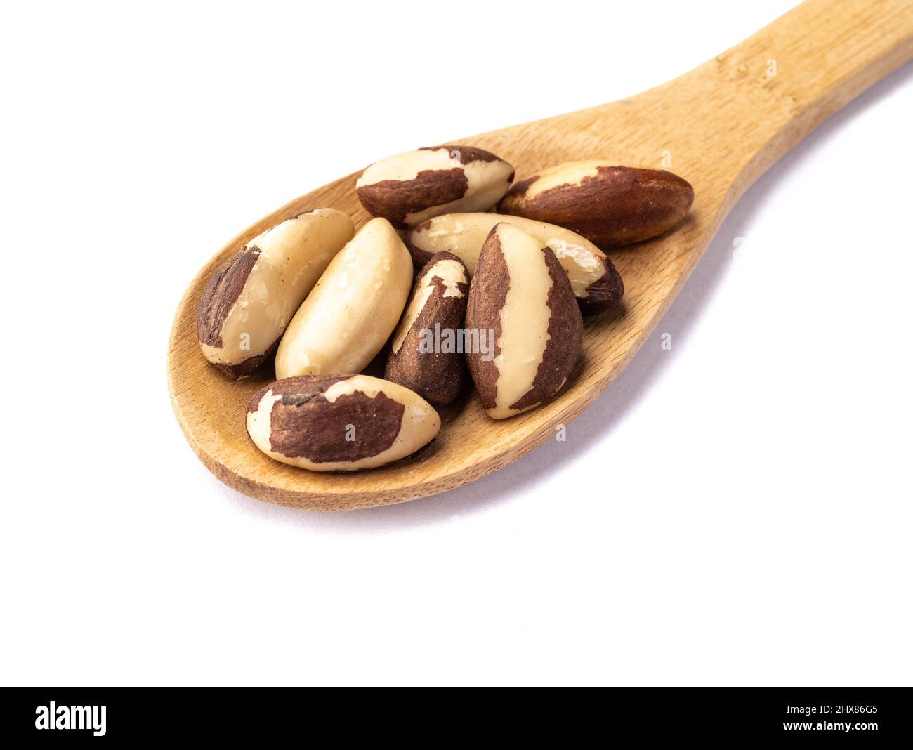 Brazil nuts in a spoon isolated over white background Stock Photo - Alamy