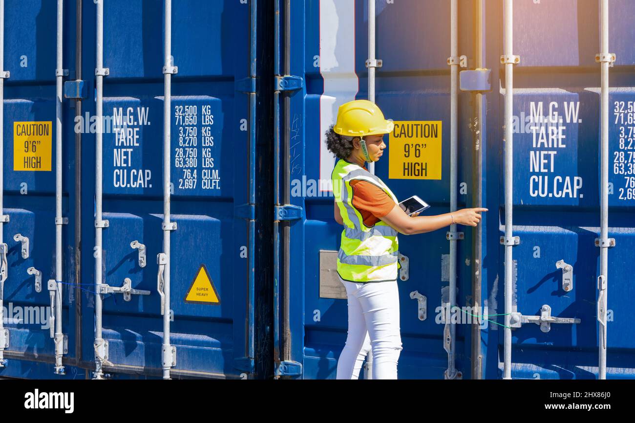 Woman foreman control loading Containers box in warehouse , Worker ...
