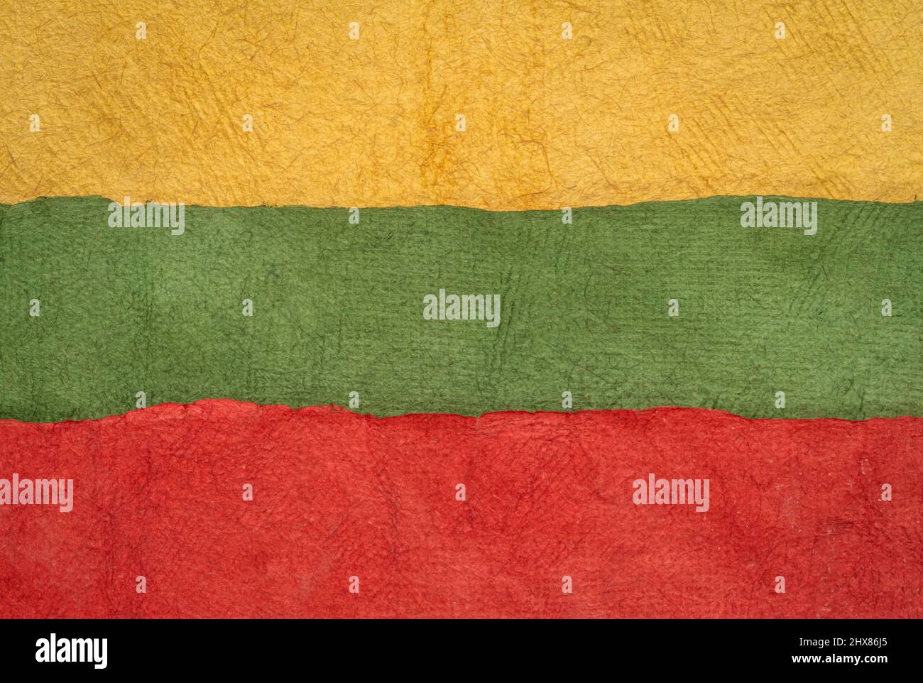 paper abstract in colors of Lithuania national flag - yellow, green and ...