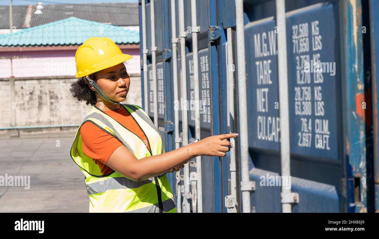 Woman foreman control loading Containers box in warehouse , Worker ...