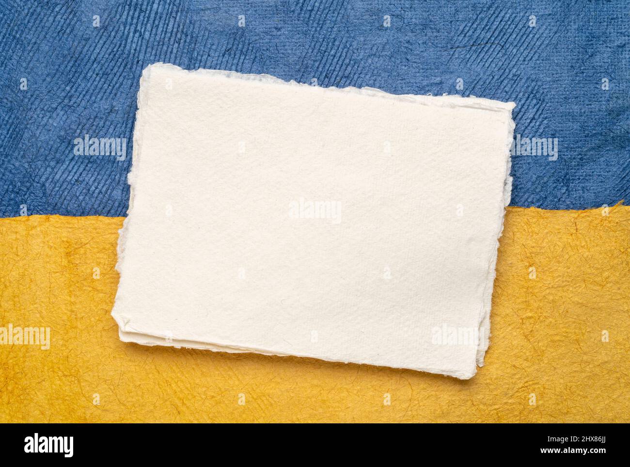 blank sheet of handmade paper against abstract in colors of Ukrainian ...