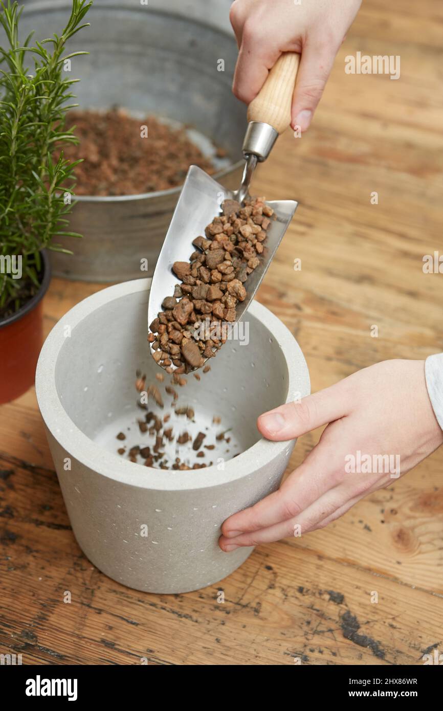 adding drainage gravel,sleeve pot Stock Photo - Alamy