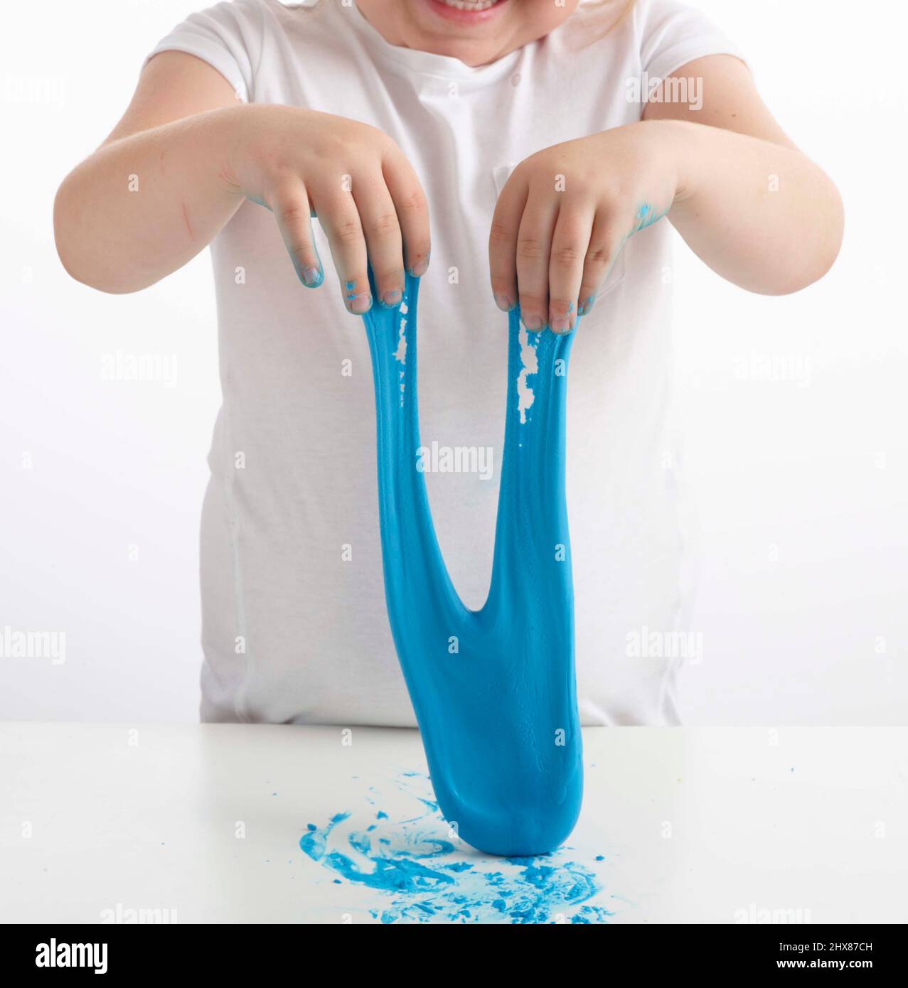 child playing with blue slime Stock Photo - Alamy