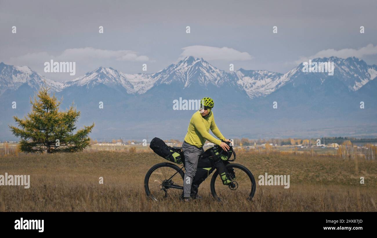 The man travel on mixed terrain cycle touring with bikepacking. The ...