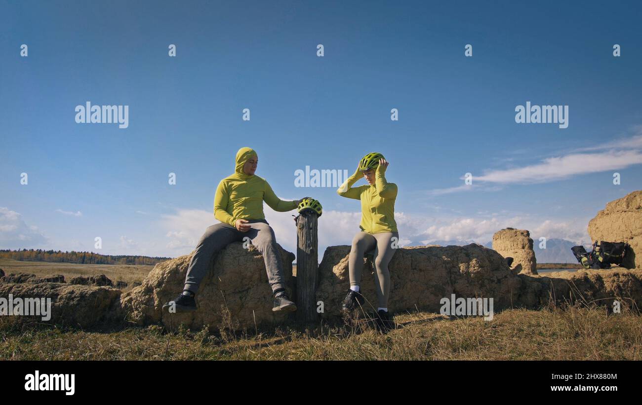 The man and woman travel on mixed terrain cycle touring with ...