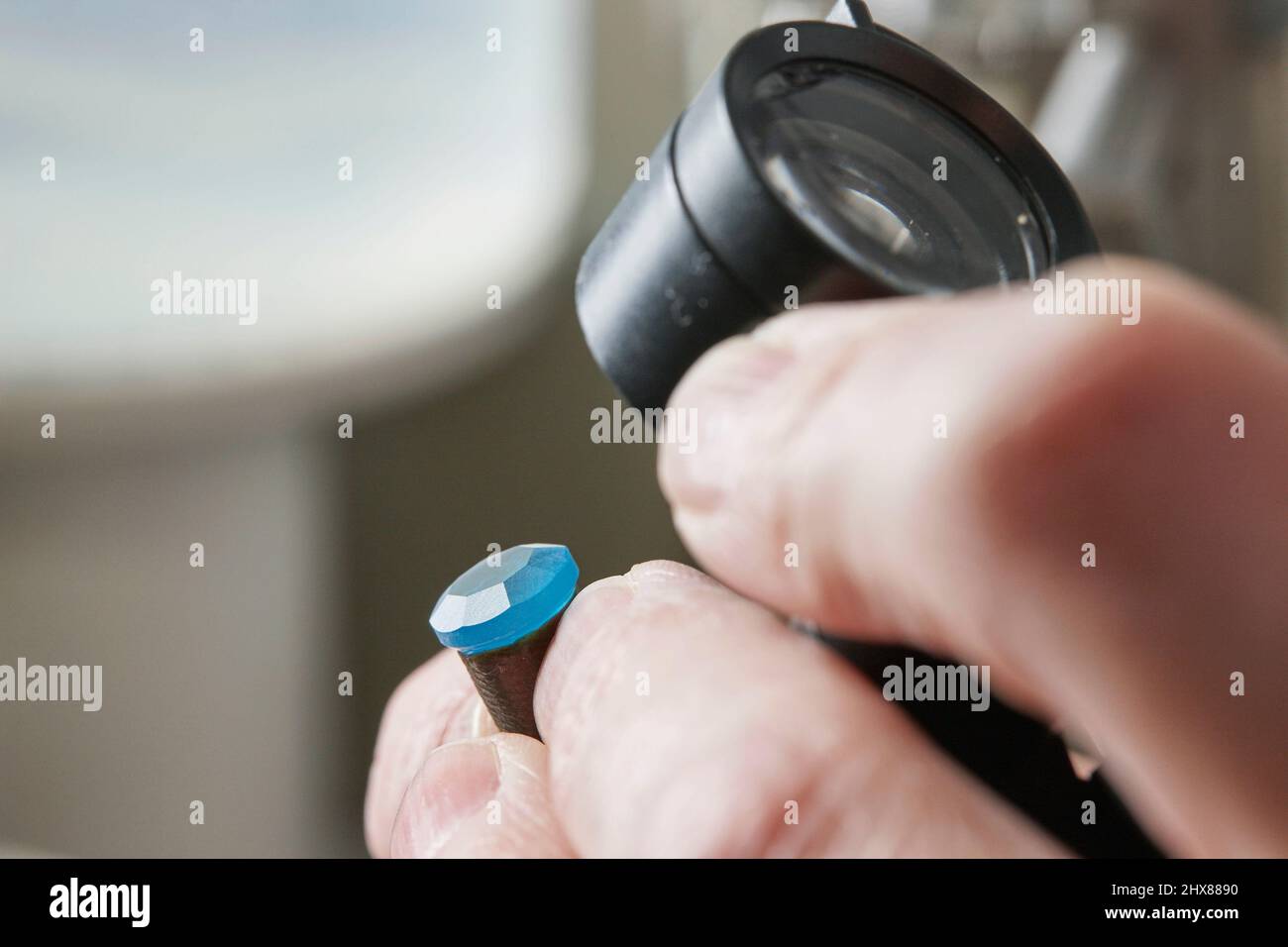 Checking the facets of a gem Stock Photo - Alamy