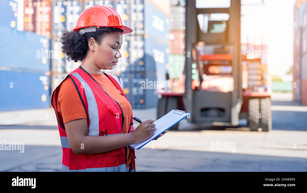 Woman foreman control loading Containers box in warehouse , Worker ...