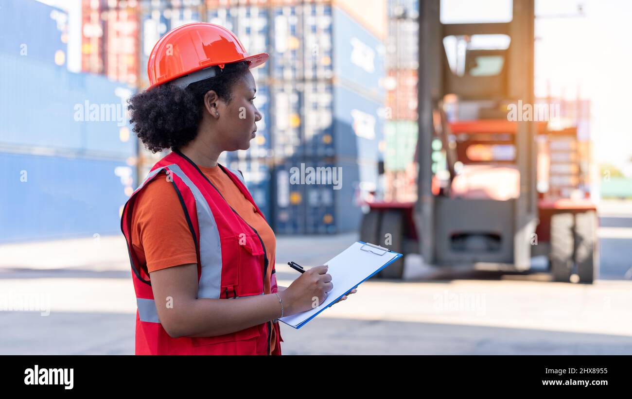 Woman foreman control loading Containers box in warehouse , Worker ...