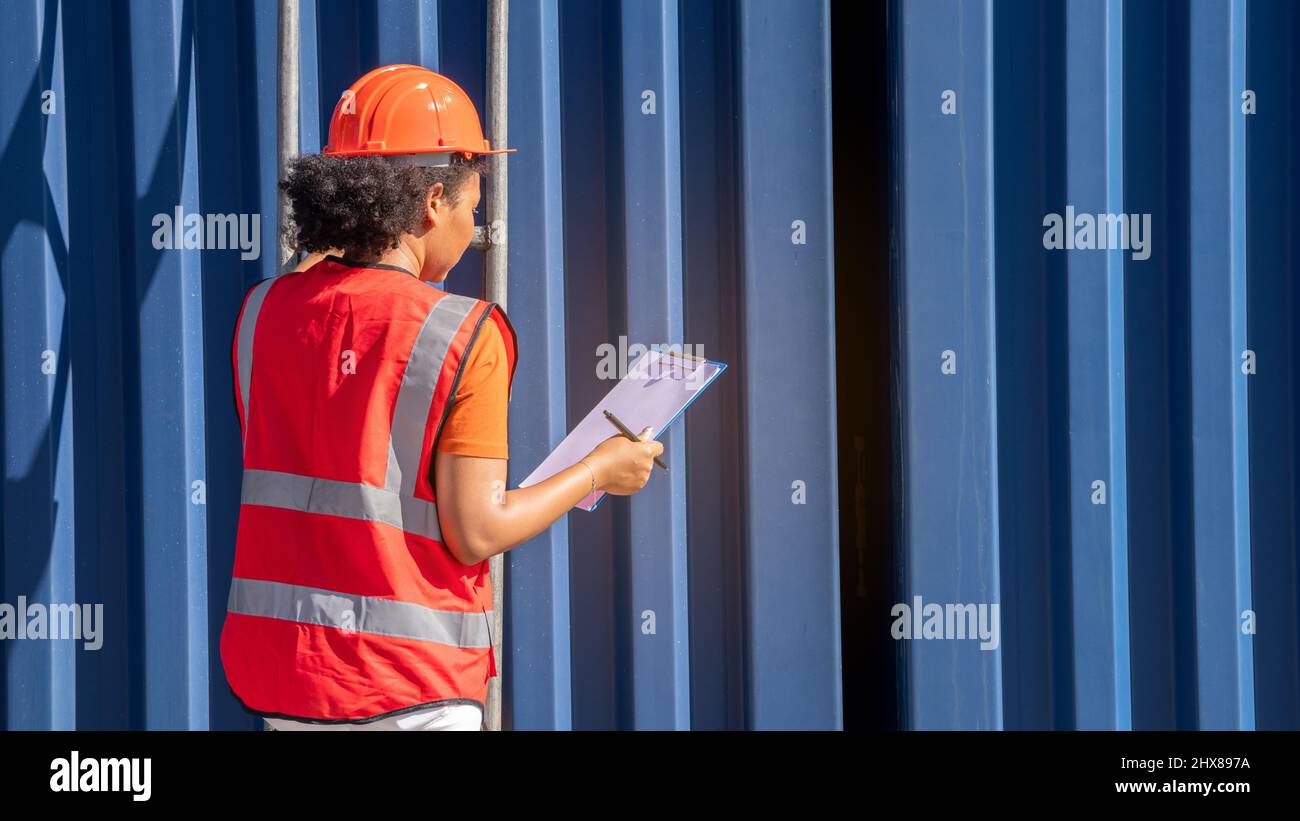 Woman foreman holding file boad for check stock at containers cargo ...