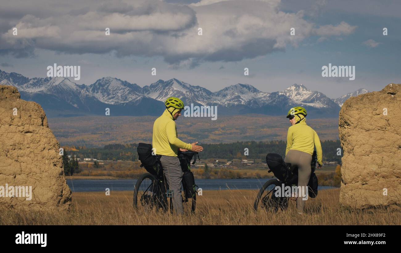The man and woman travel on mixed terrain cycle bike touring with ...