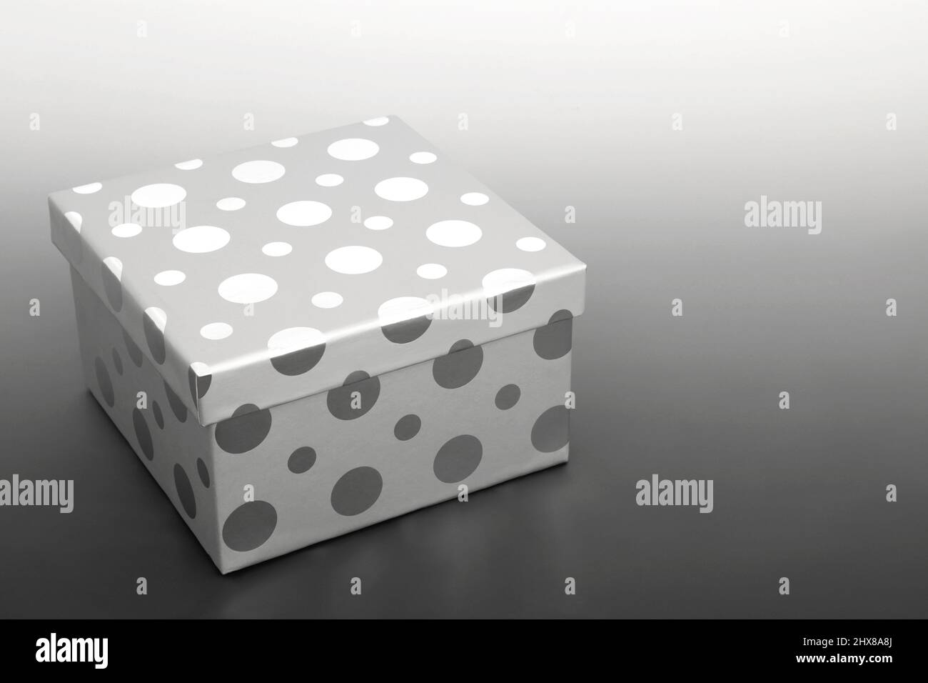 Gift box cube shaped silver and grey polka dot design on gradient ...