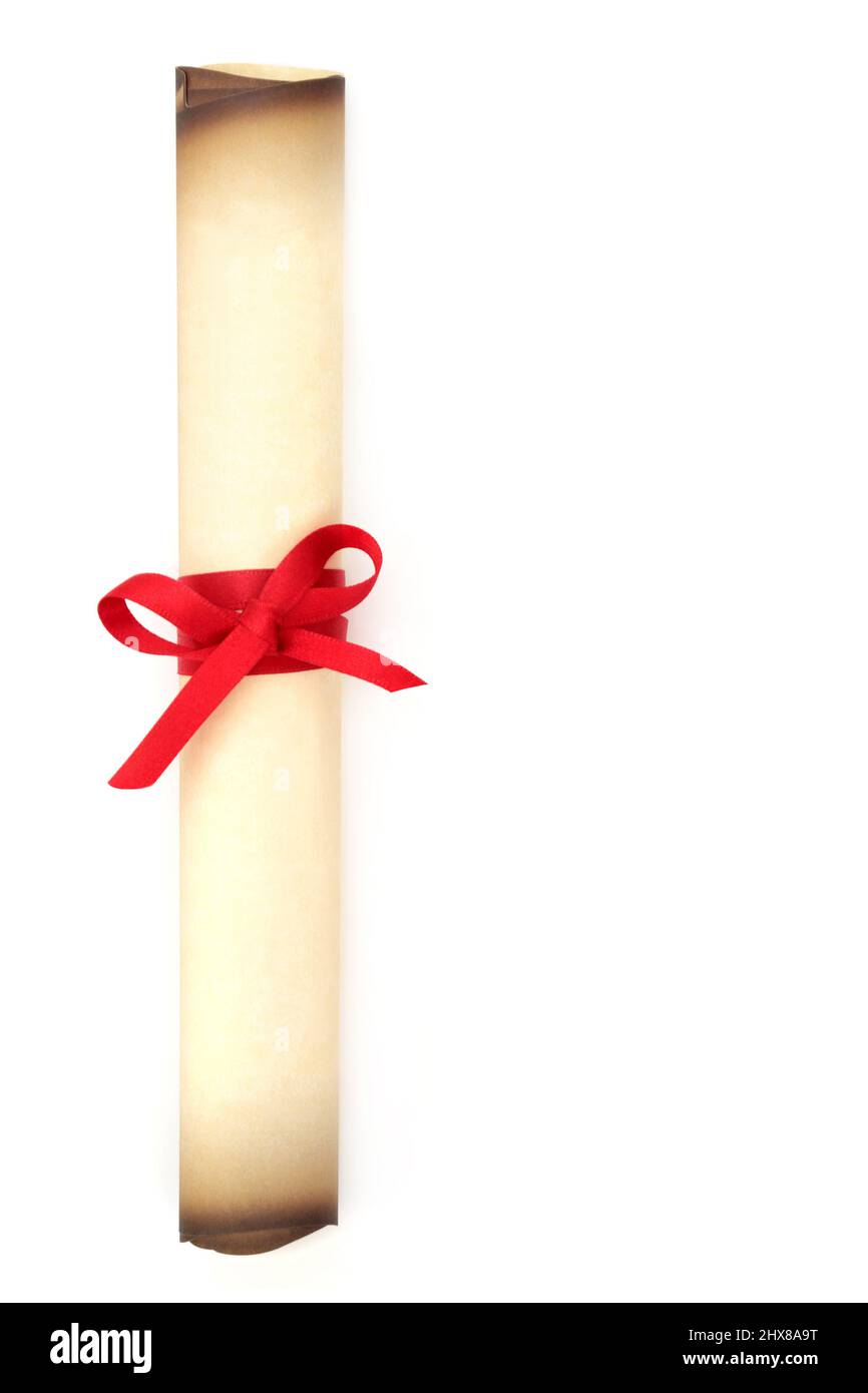 Old parchment scroll rolled up and tied with red ribbon. On white ...