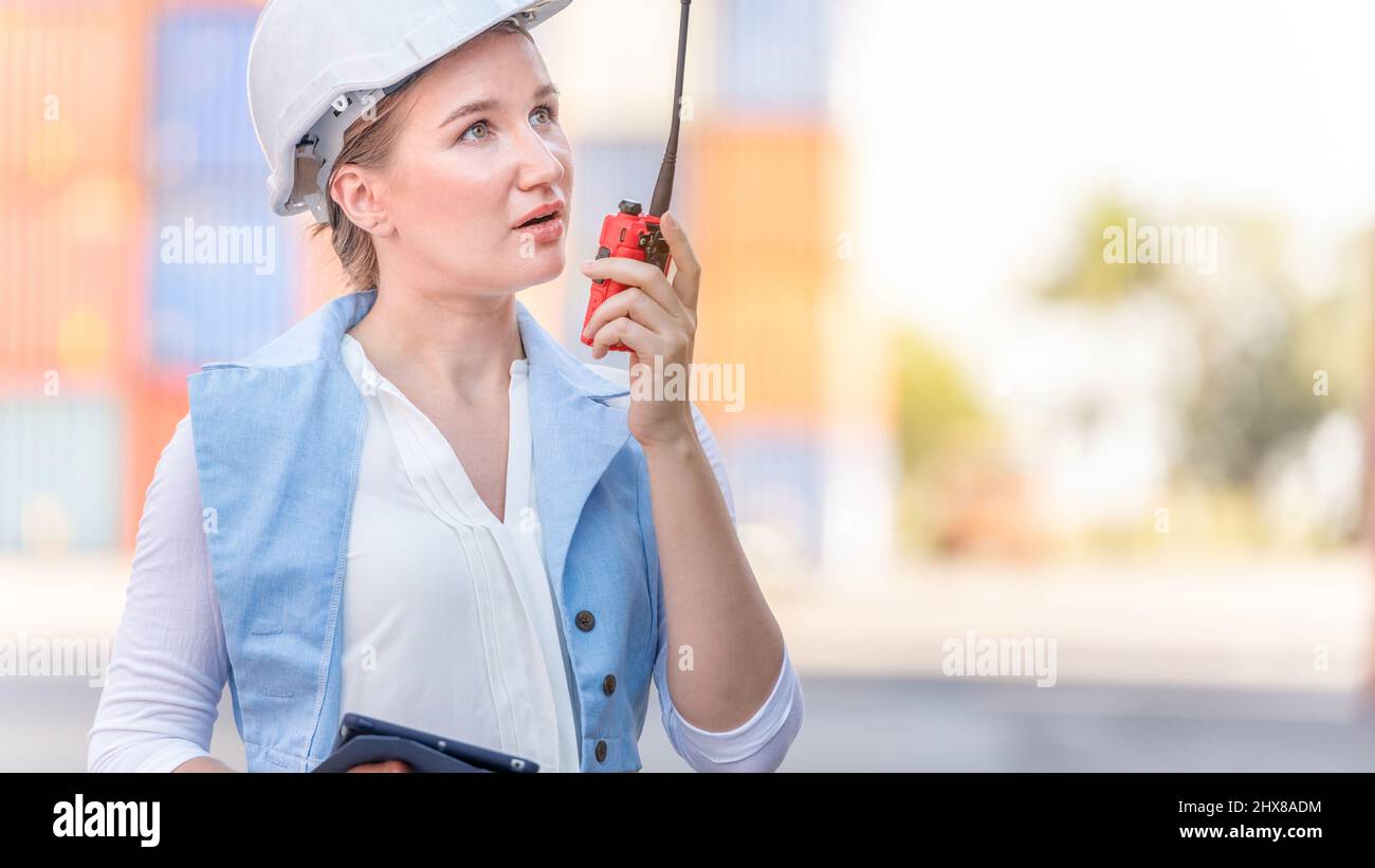 CEO or Manager Woman in white helmet control loading Containers box in ...