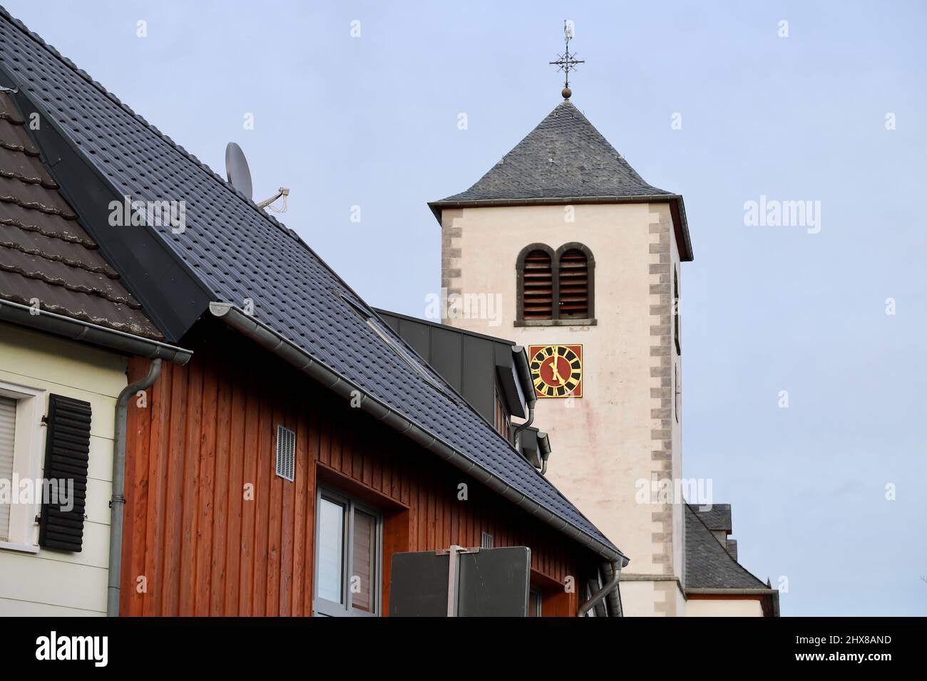 tower of a church behind roof Stock Photo - Alamy