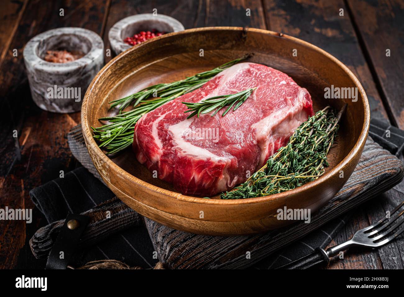 Rib-eye raw Steak, rib eye beef marbled meat in wooden plate with ...