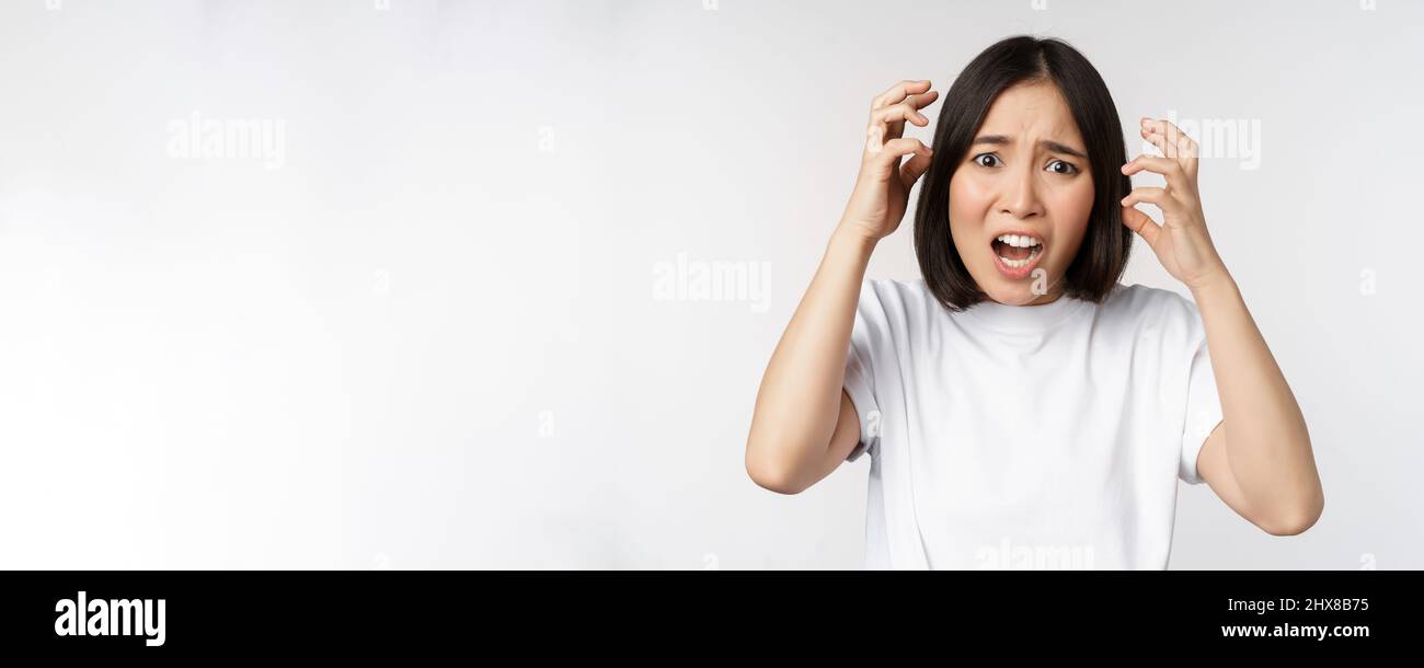 Korean woman freaking out, shaking hands and shouting in panic ...