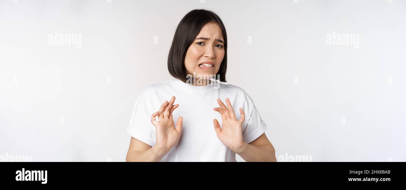 Disgusted asian woman rejecting smth, grimacing from dislike and ...