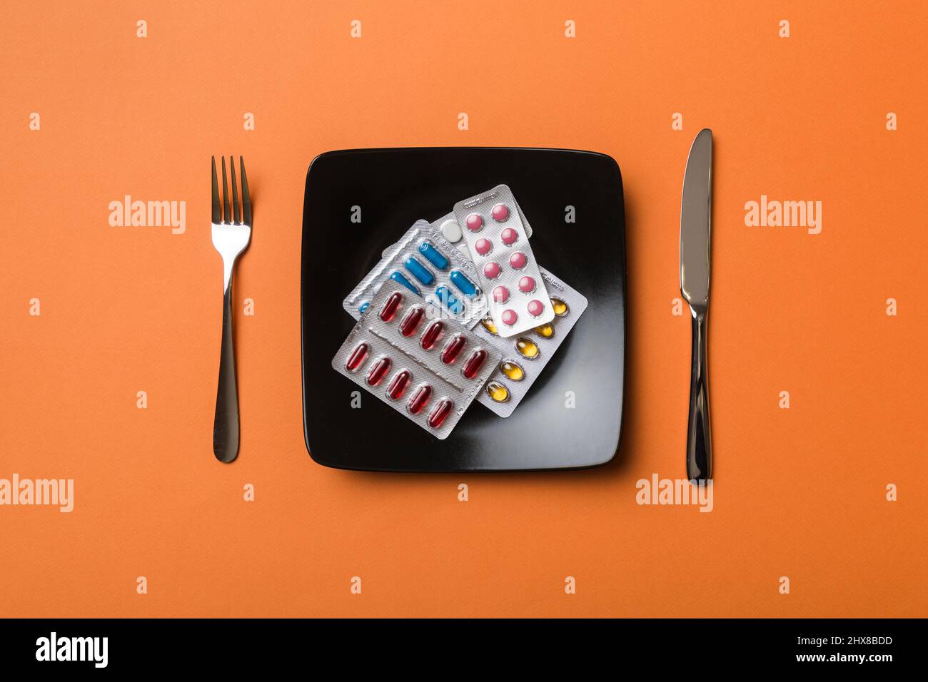 Many different weight loss pills and supplements as food on round plate ...