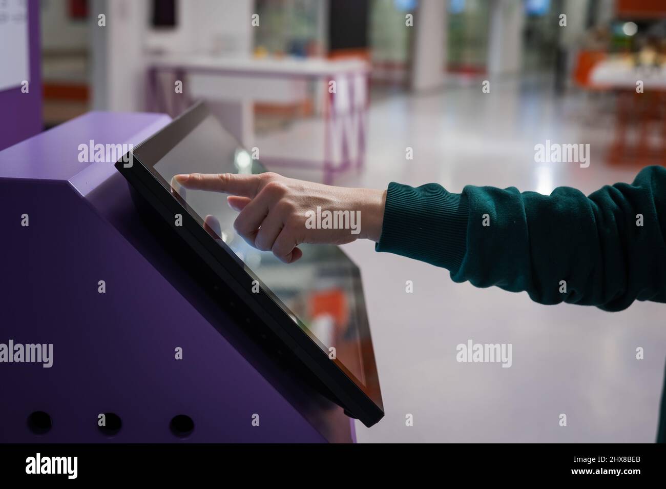 Close-up of a woman using a touch screen information booth Stock Photo ...