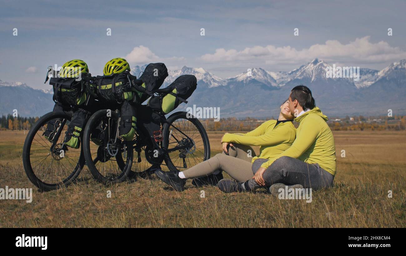 The man and woman travel on mixed terrain cycle touring with ...