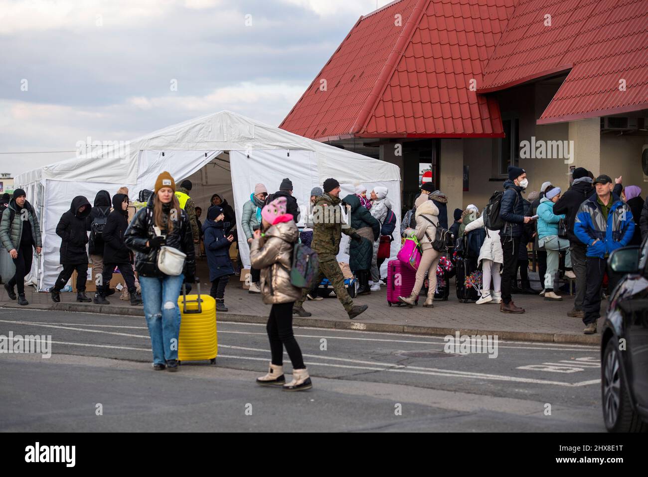 Korczowa, Poland. 10th Mar, 2022. Refugees from Ukraine are standing at ...