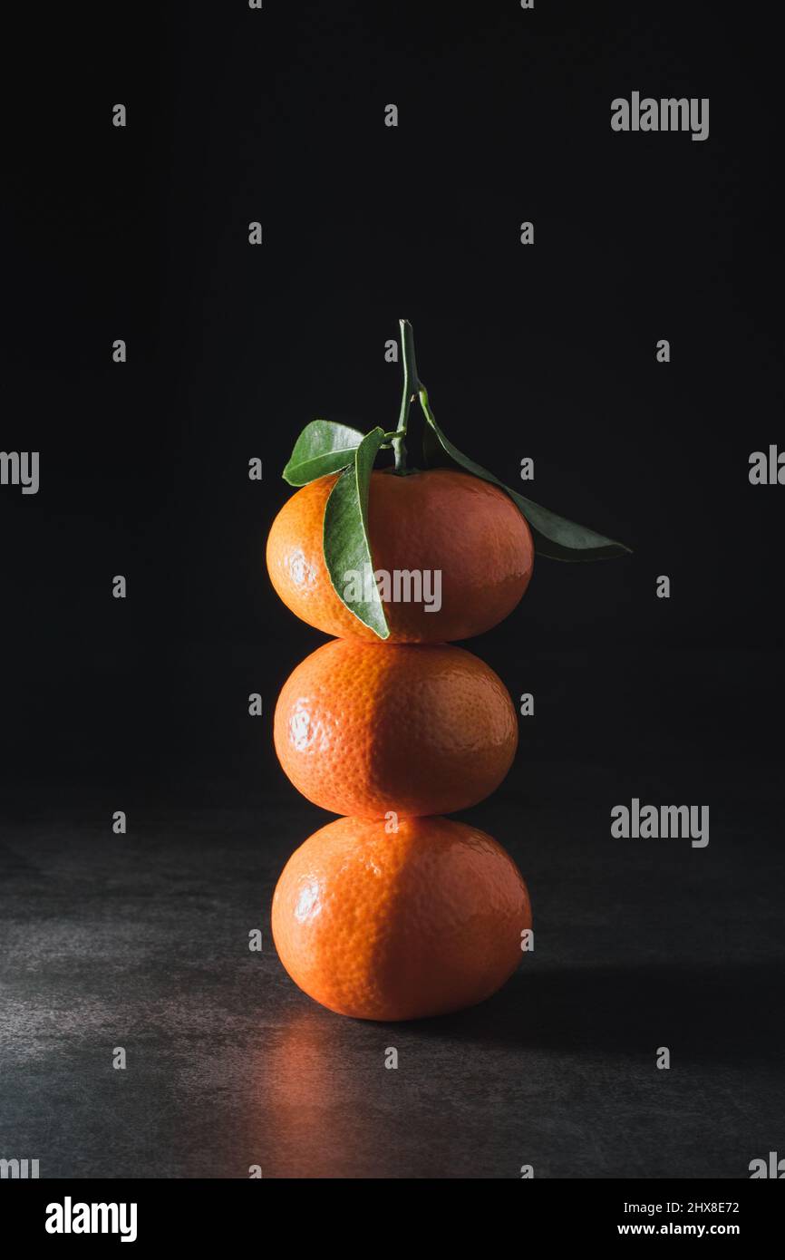 Fresh mandarin with leaves on dark background Stock Photo - Alamy