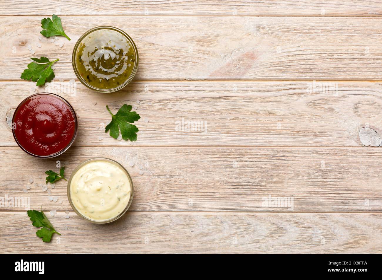 Many different sauces and herbs on table, flat lay top view. sauces ...