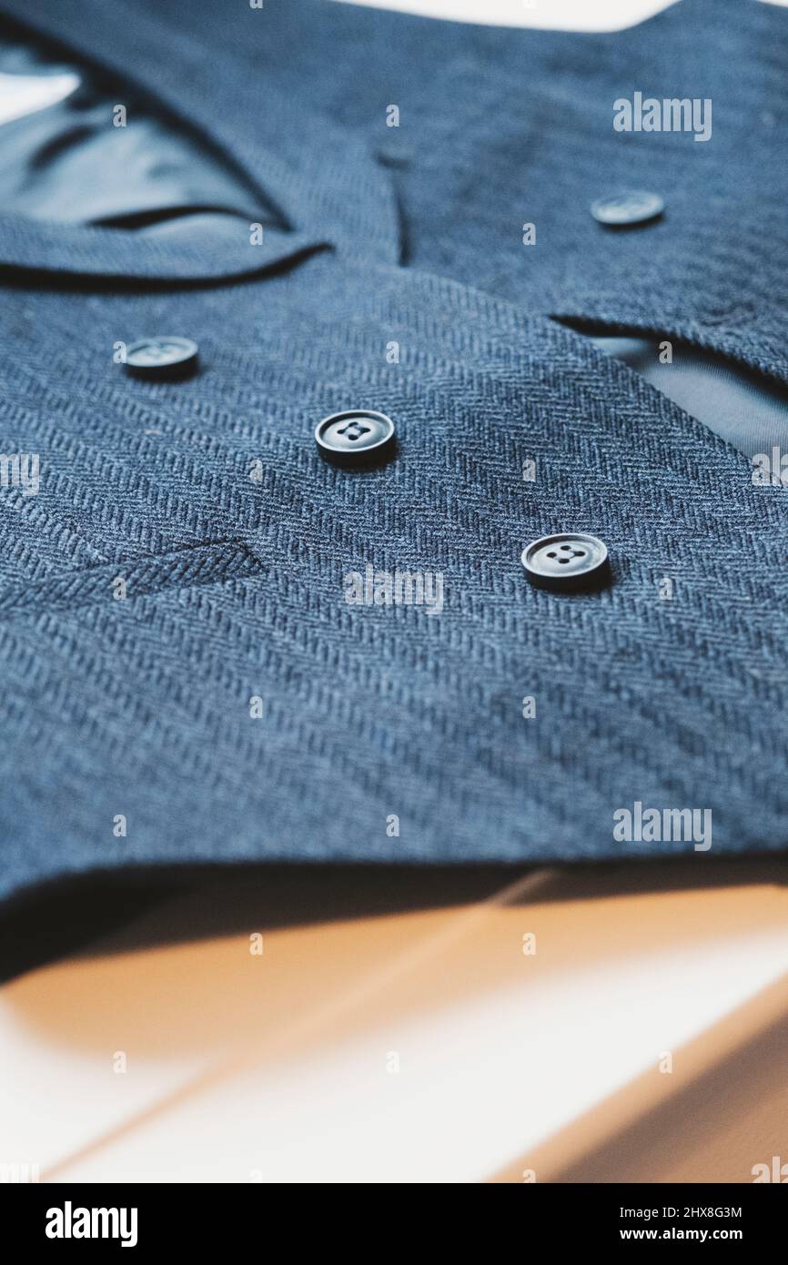 A wedding waistcoat isolated on a desk, showing the buttons up close ...