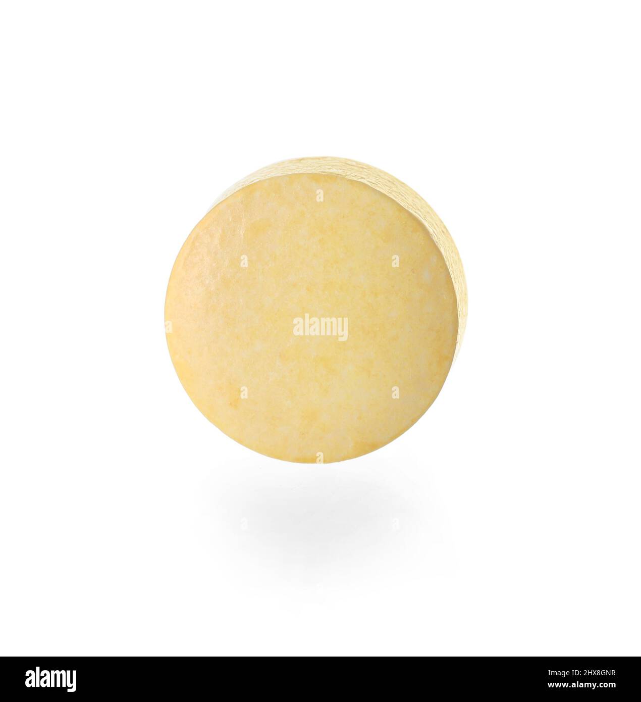 Yellow pill on white background Stock Photo - Alamy