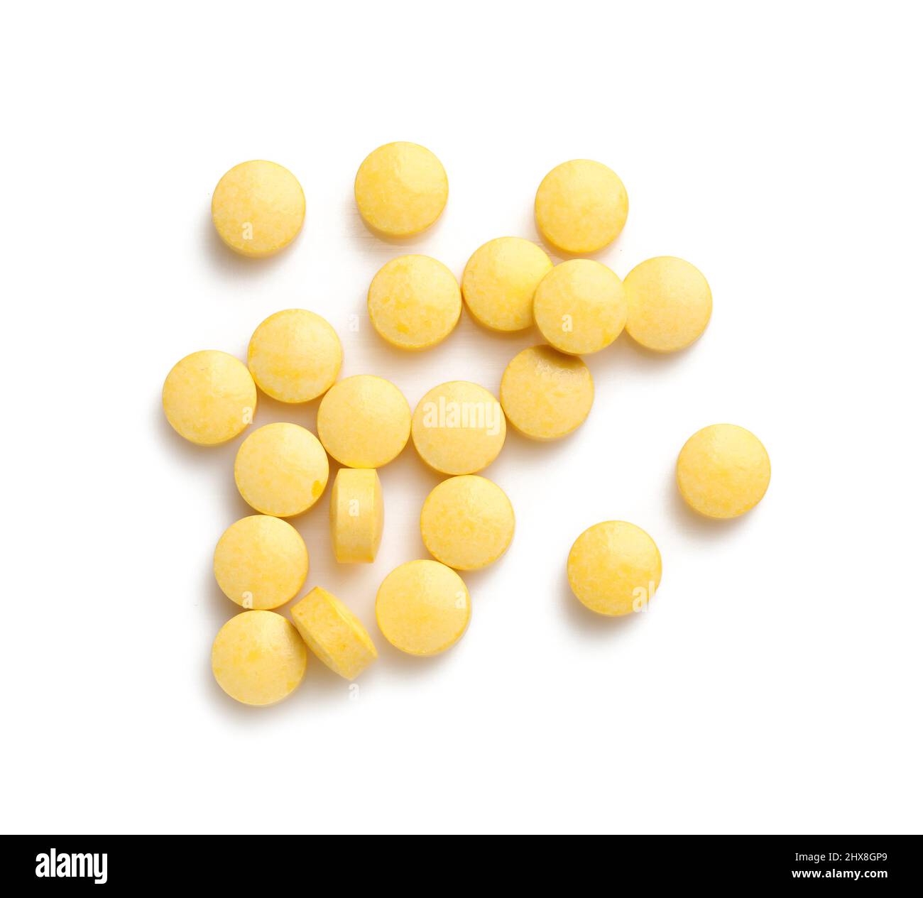 Yellow pills on white background Stock Photo - Alamy