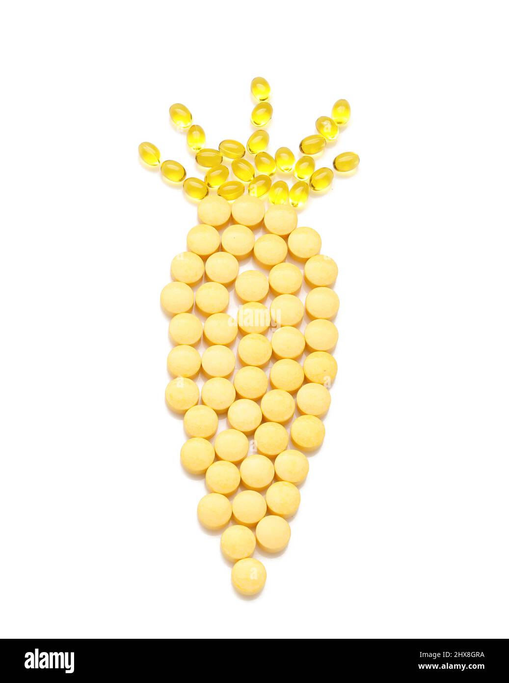 Carrot shape made of pills on white background Stock Photo - Alamy