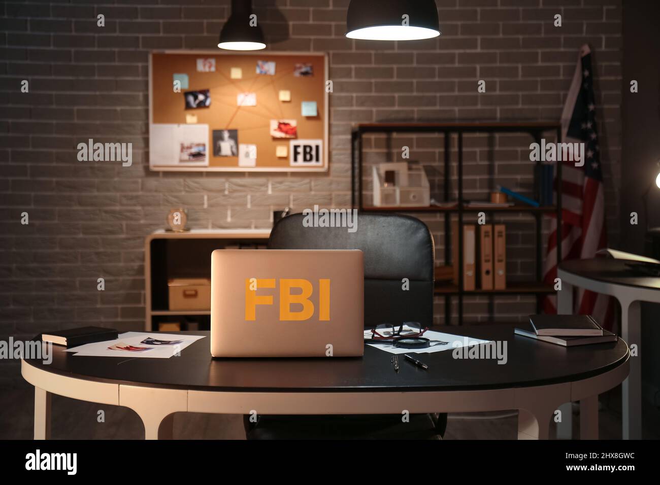 Workplace of FBI agent with laptop in office at night Stock Photo - Alamy