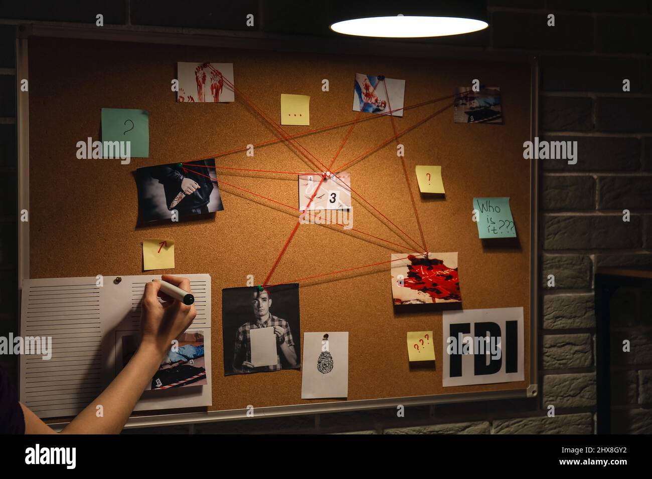 Detective processing evidence in FBI agent's office Stock Photo - Alamy