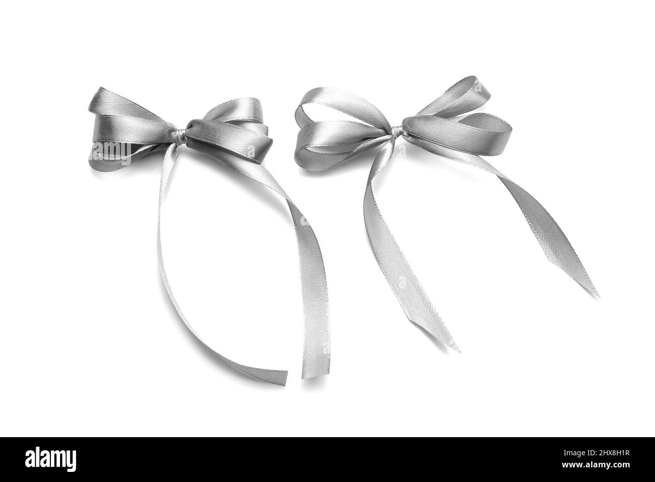 Beautiful silver ribbon bows on white background Stock Photo - Alamy