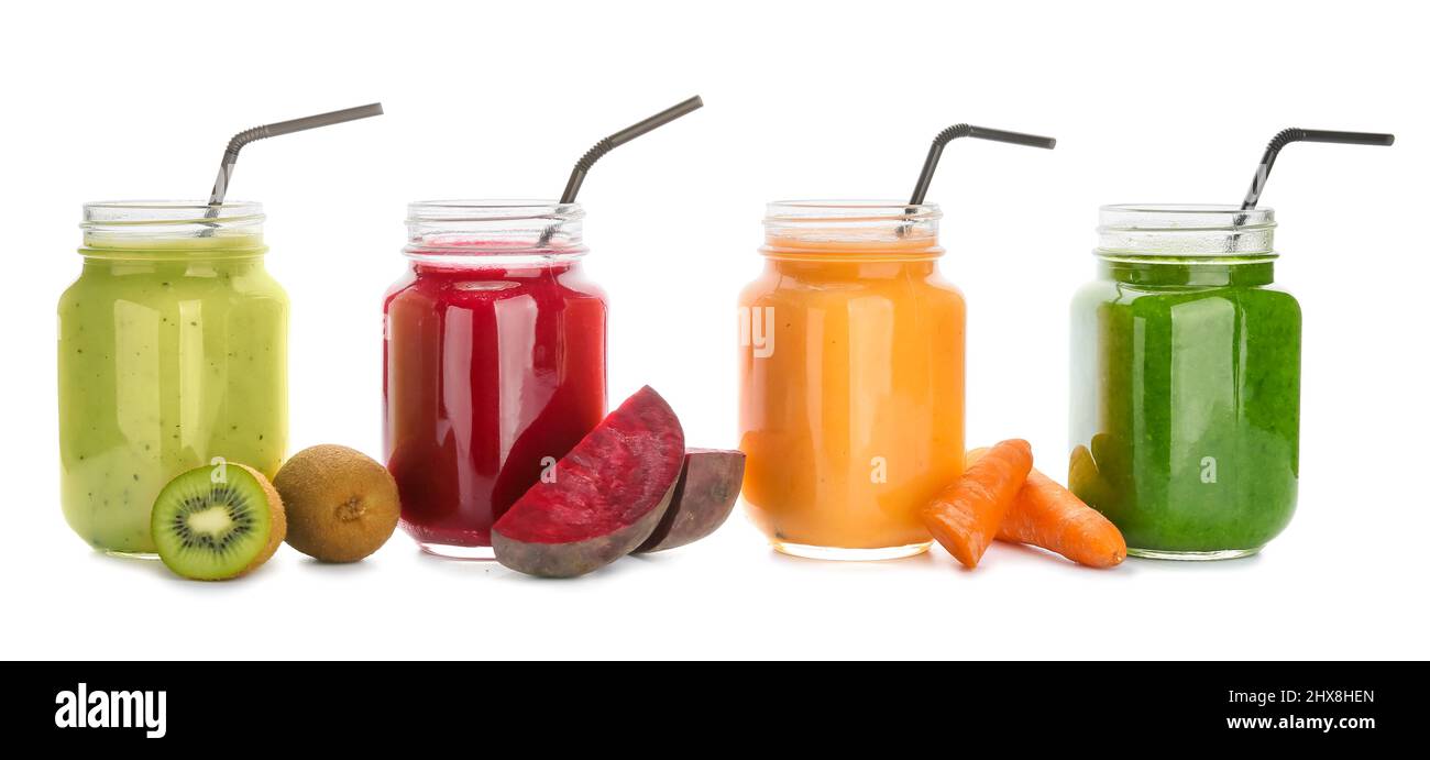 Mason jars of healthy smoothie with fruits and vegetables on white ...