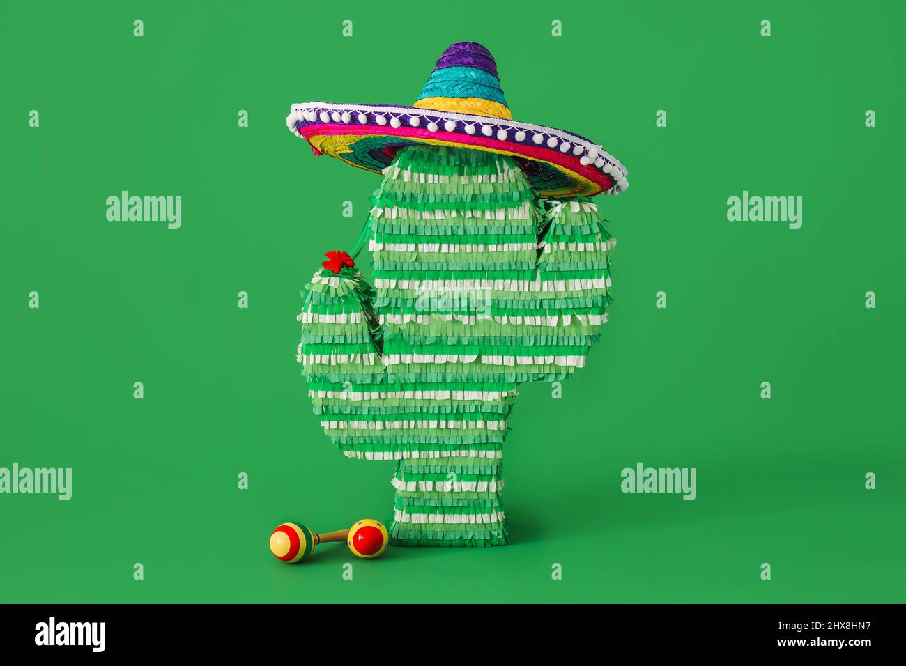 Mexican pinata in shape of cactus with sombrero hat and maracas on ...