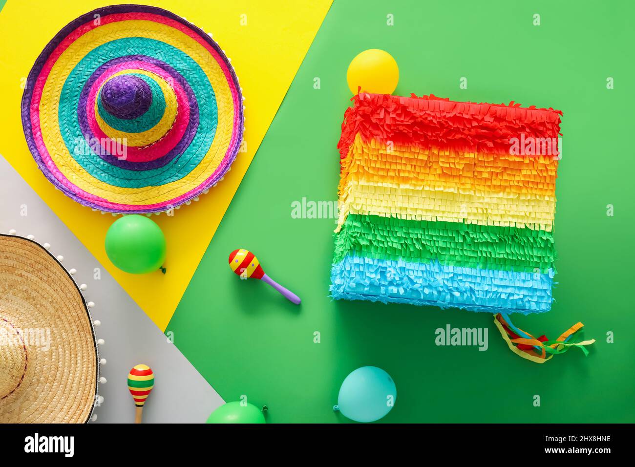 Mexican pinata in shape of cube with sombrero hats, balloons and ...