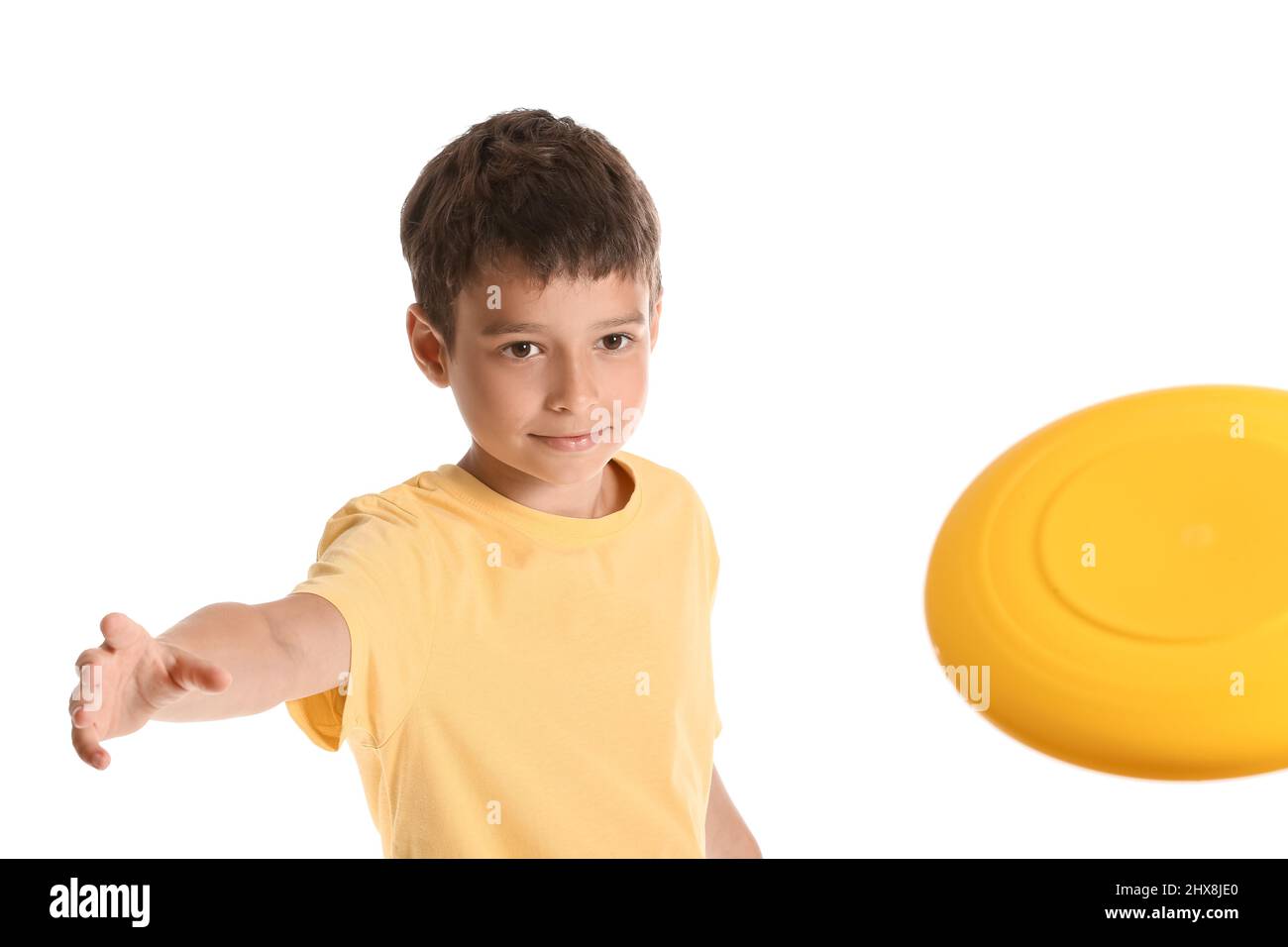 Funny little boy playing frisbee on white background Stock Photo - Alamy