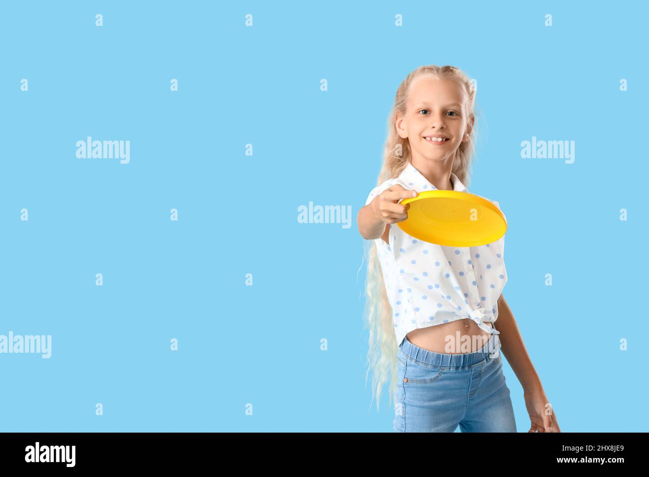 Funny little girl playing frisbee on color background Stock Photo - Alamy
