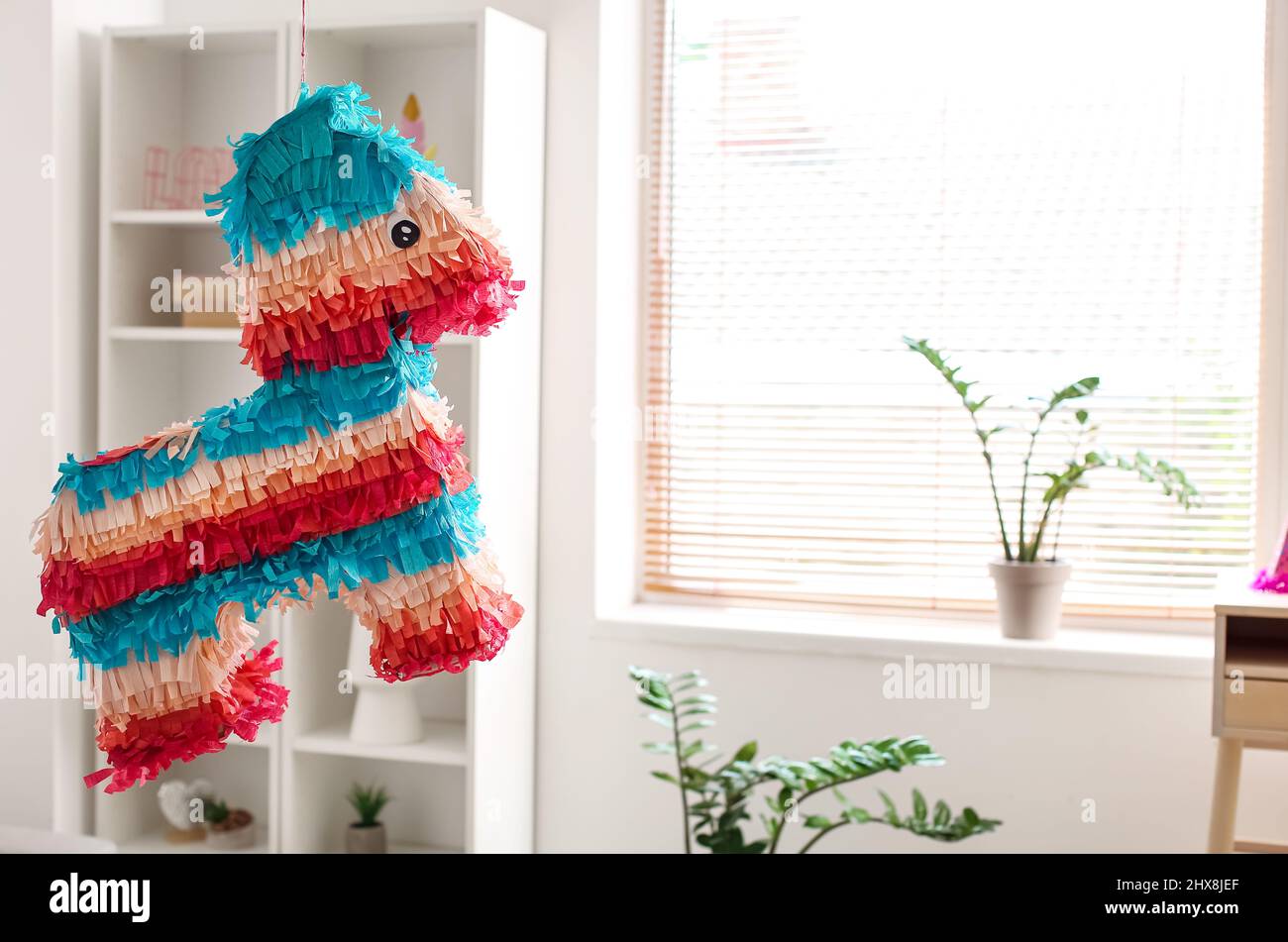 Mexican pinata hanging in living room Stock Photo - Alamy