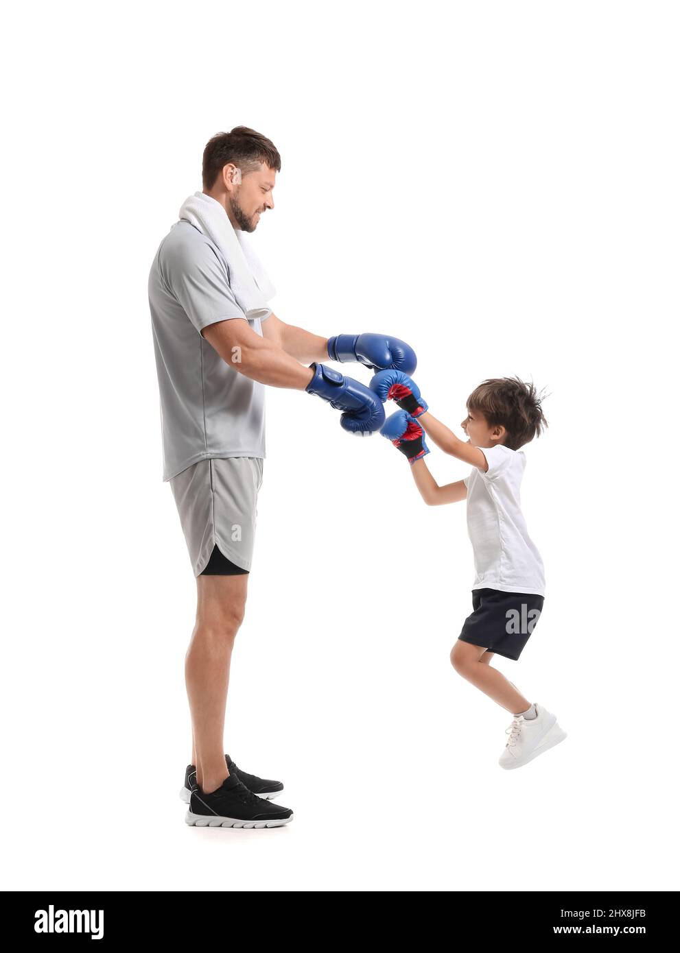 Little boy training with boxing coach on white background Stock Photo ...