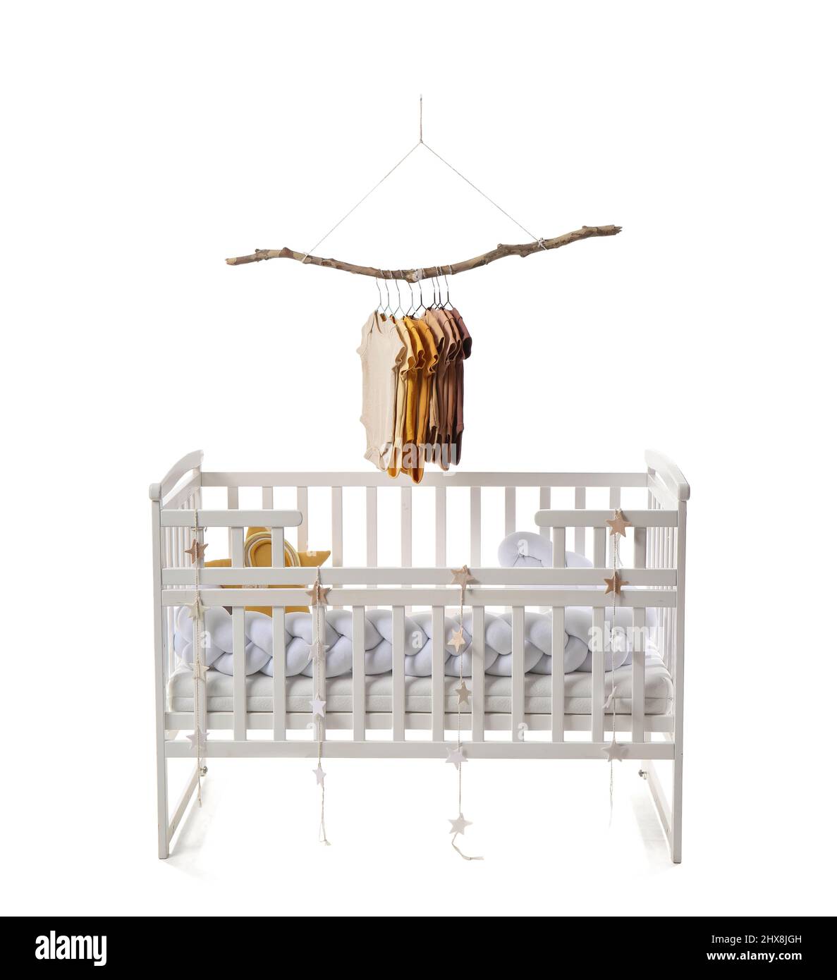 Tree branch with baby bodysuits and crib on white background Stock ...