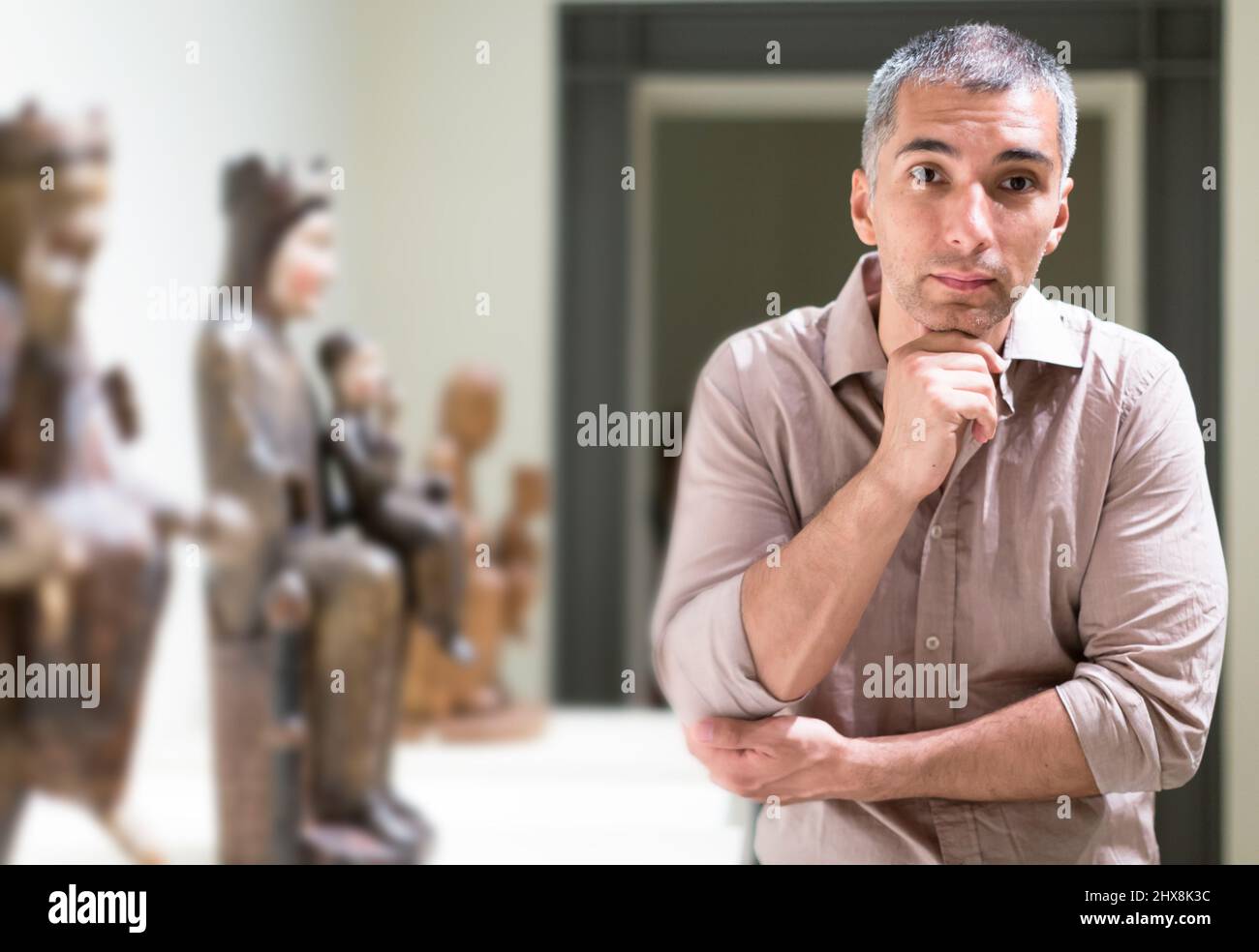 Adult man is visiting museum and looking at the exposition Stock Photo ...