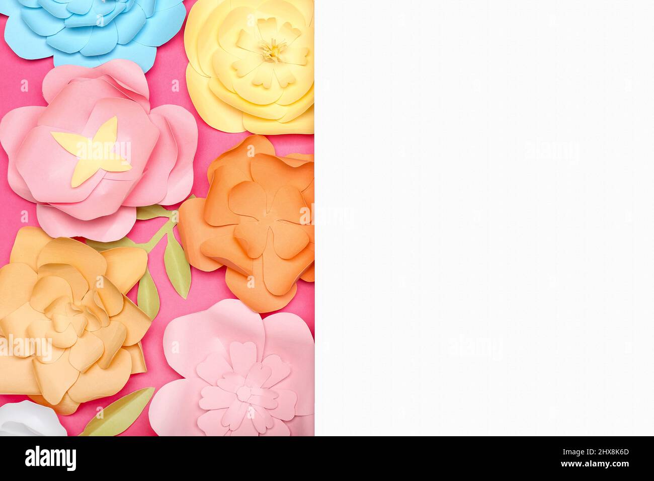 Handmade paper flowers and blank poster on color background Stock Photo ...