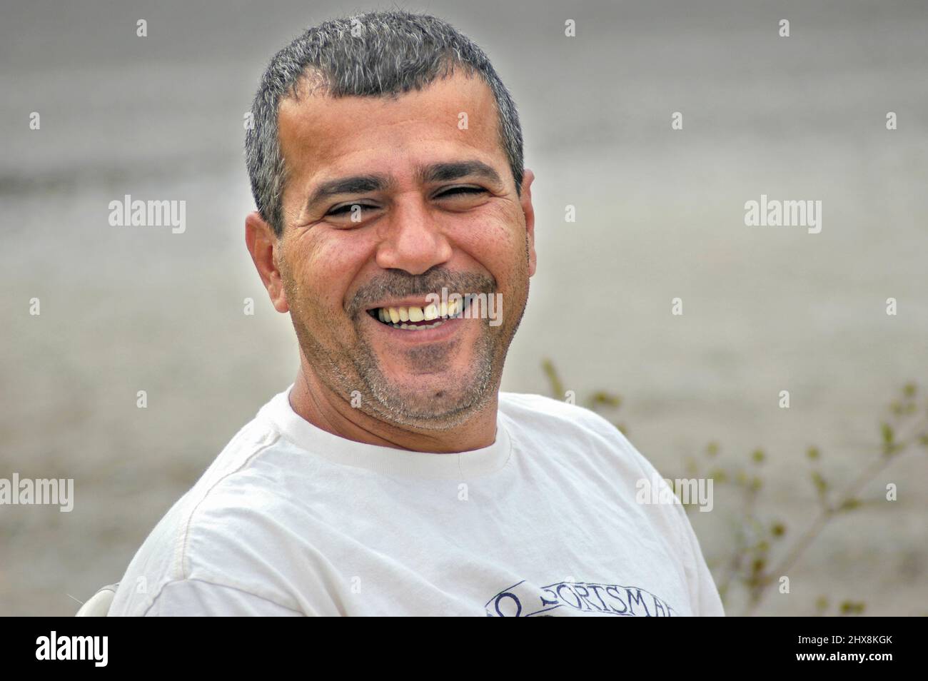 Smiling short haired portrait face of a Middle aged Greek Man in white ...
