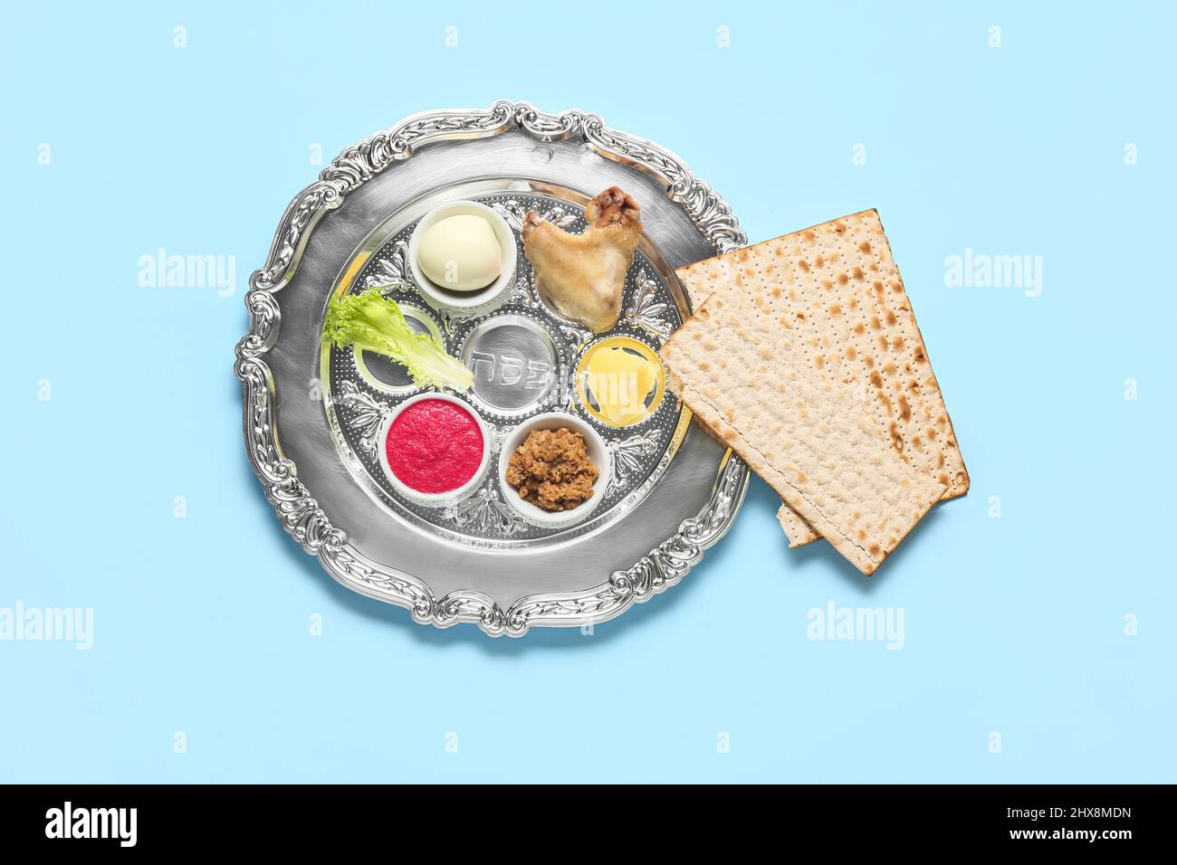 Passover Seder plate with traditional food on color background, top ...