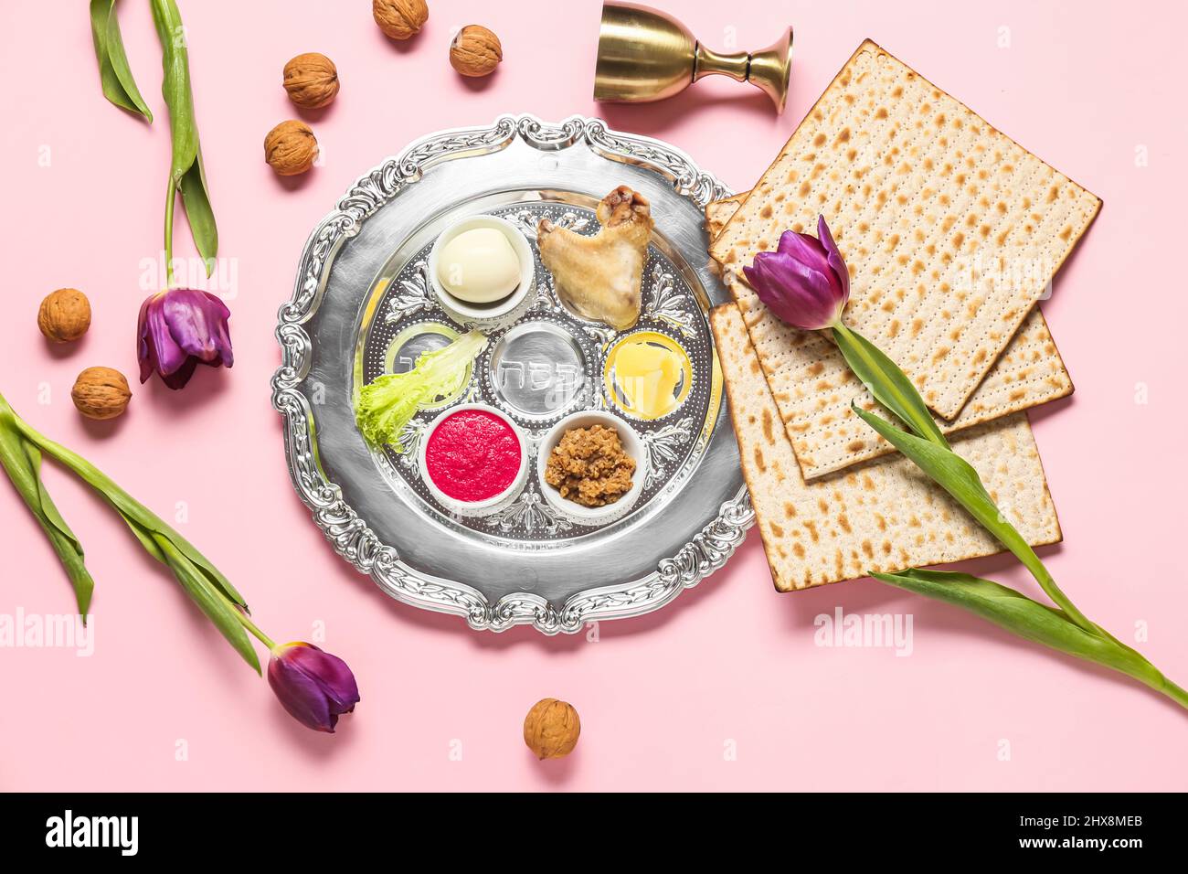Passover Seder plate with traditional food and tulip flowers on color background Stock Photo - Alamy