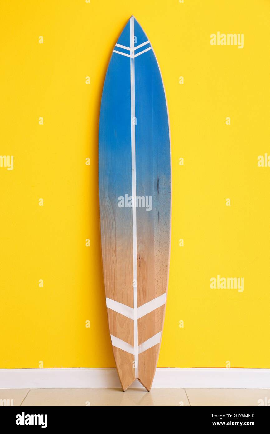 Blue surfboard near yellow wall Stock Photo - Alamy