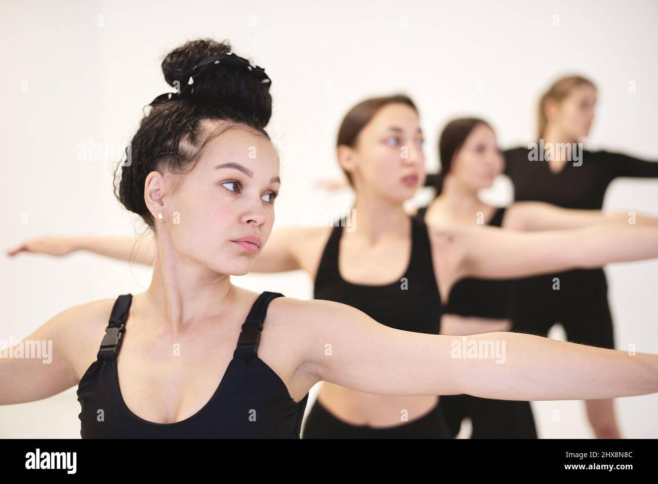 The trainer shows how to stretch correctly to a group involved in ...
