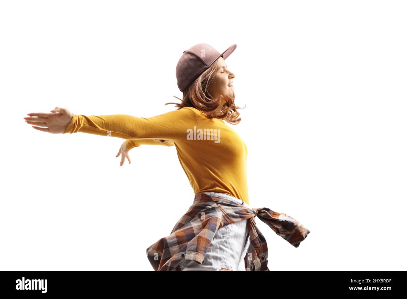 Full length profile shot of a young woman on wind throwing hands ...